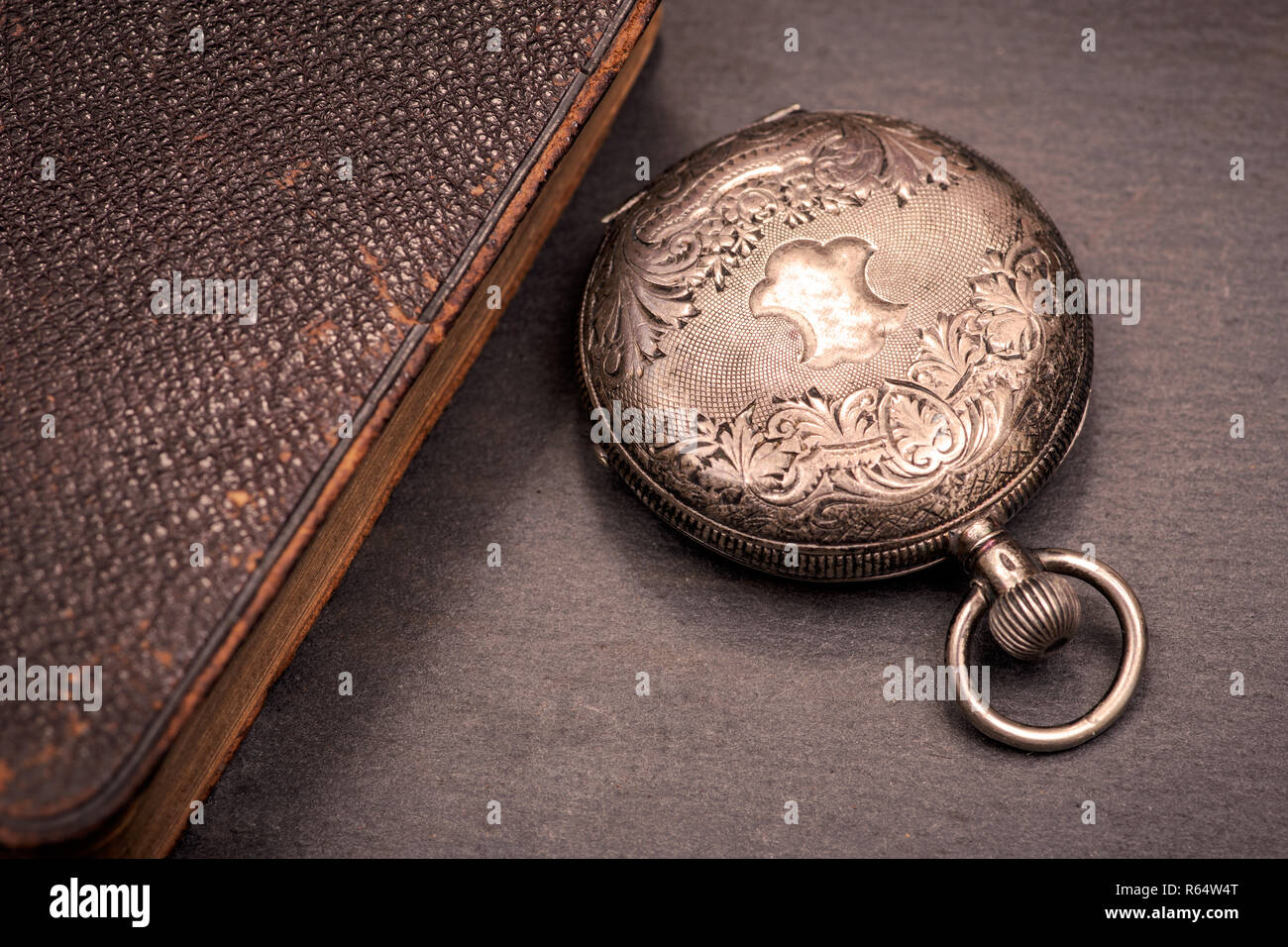 Panta rhei concept: antique pocket watch and pile of vintage hard cover ...
