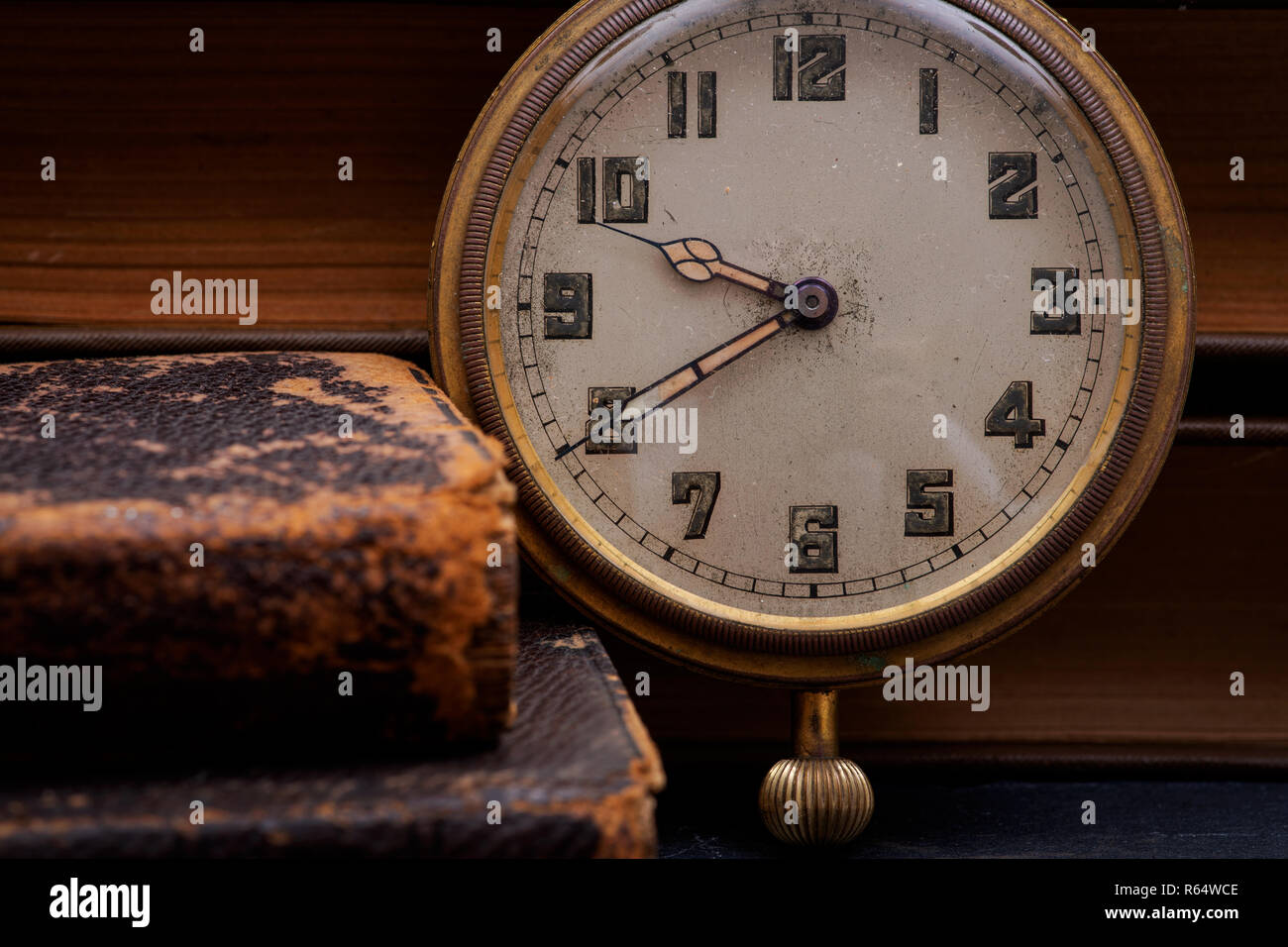 Panta rhei concept: antique pocket watch and pile of vintage hard cover ...