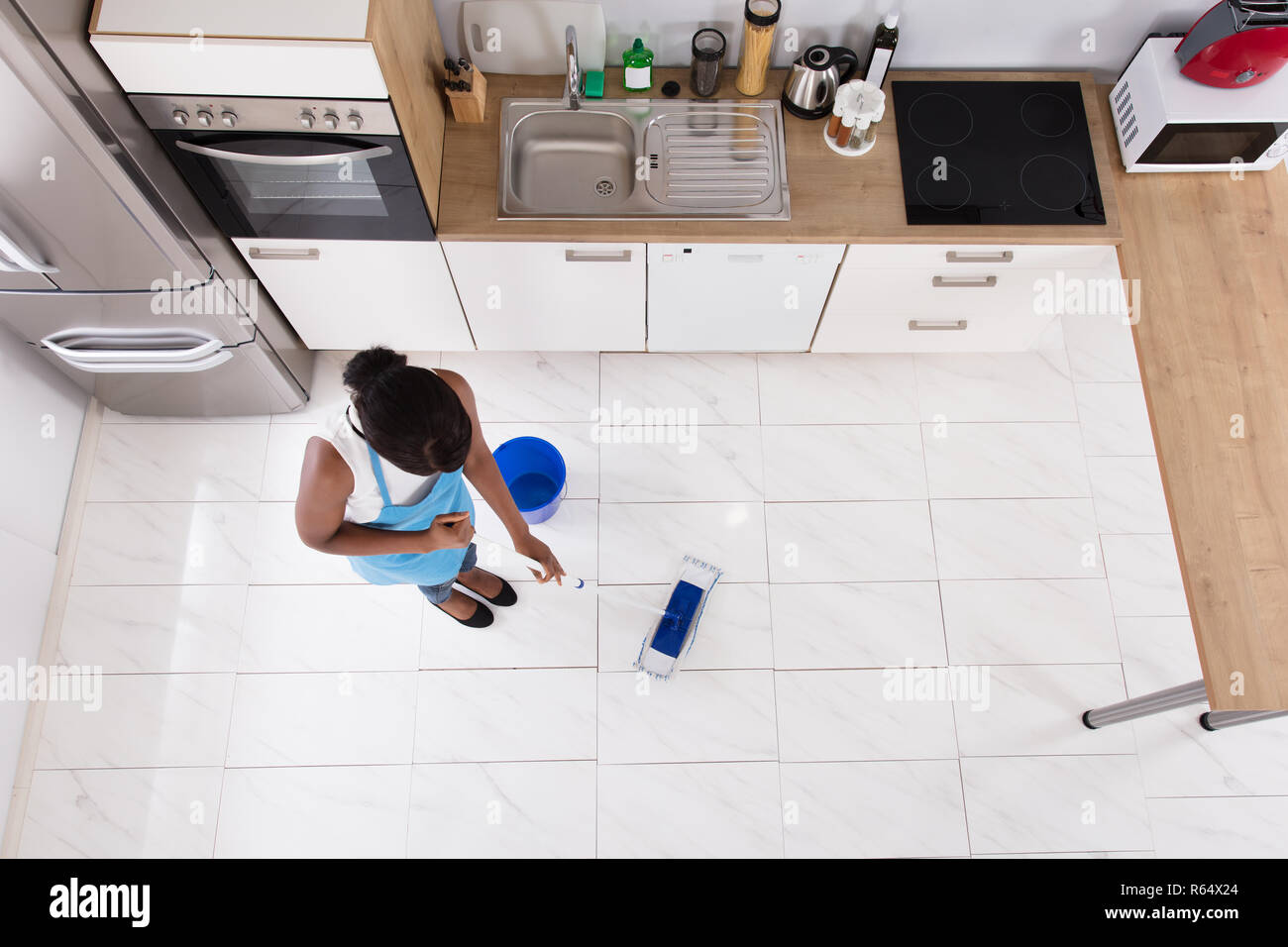 Housewife Cleaning Floor With Mop Stock Photo - Alamy