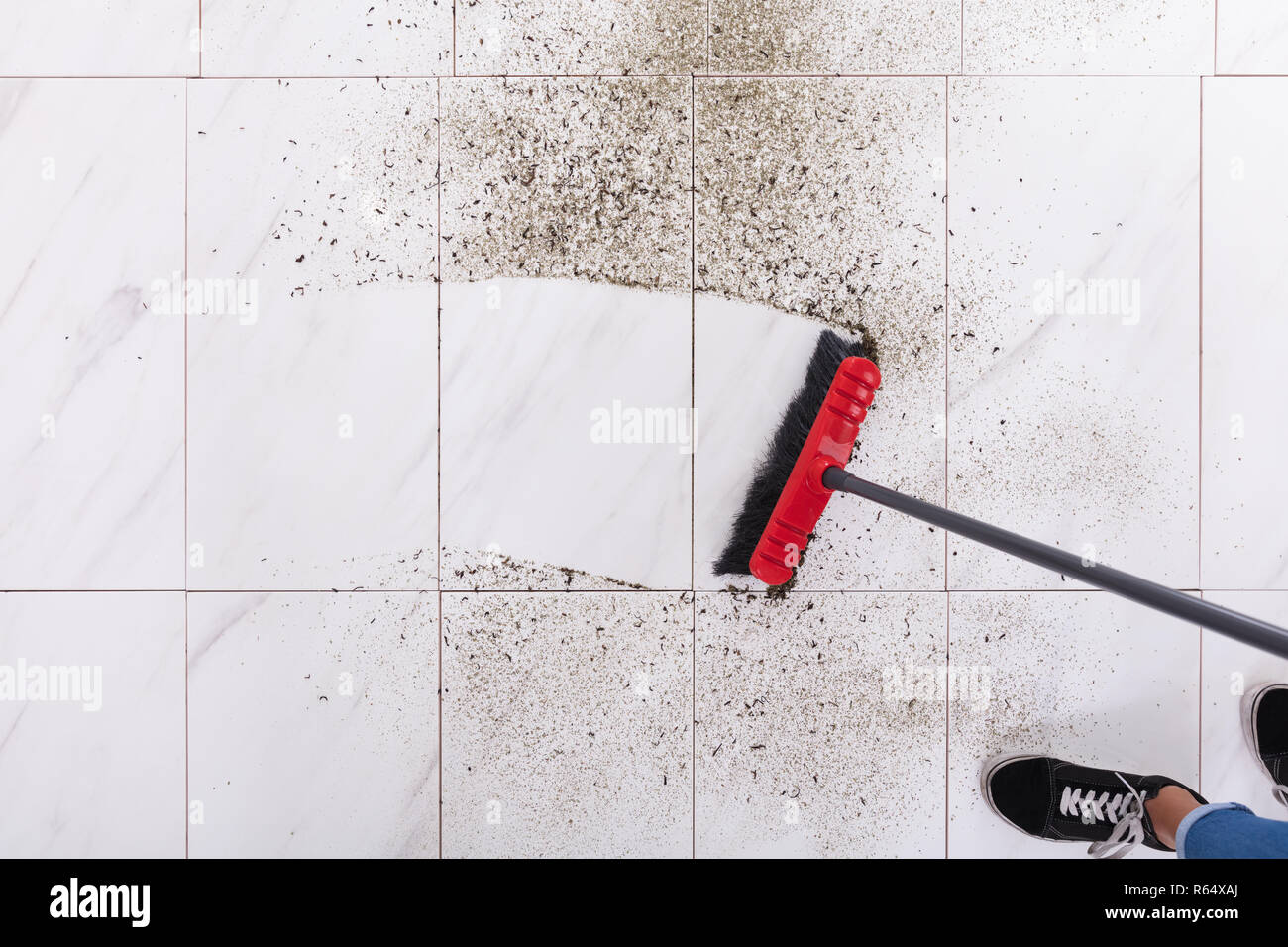 Broom Cleaning Dirt On Tiled Floor Stock Photo - Alamy