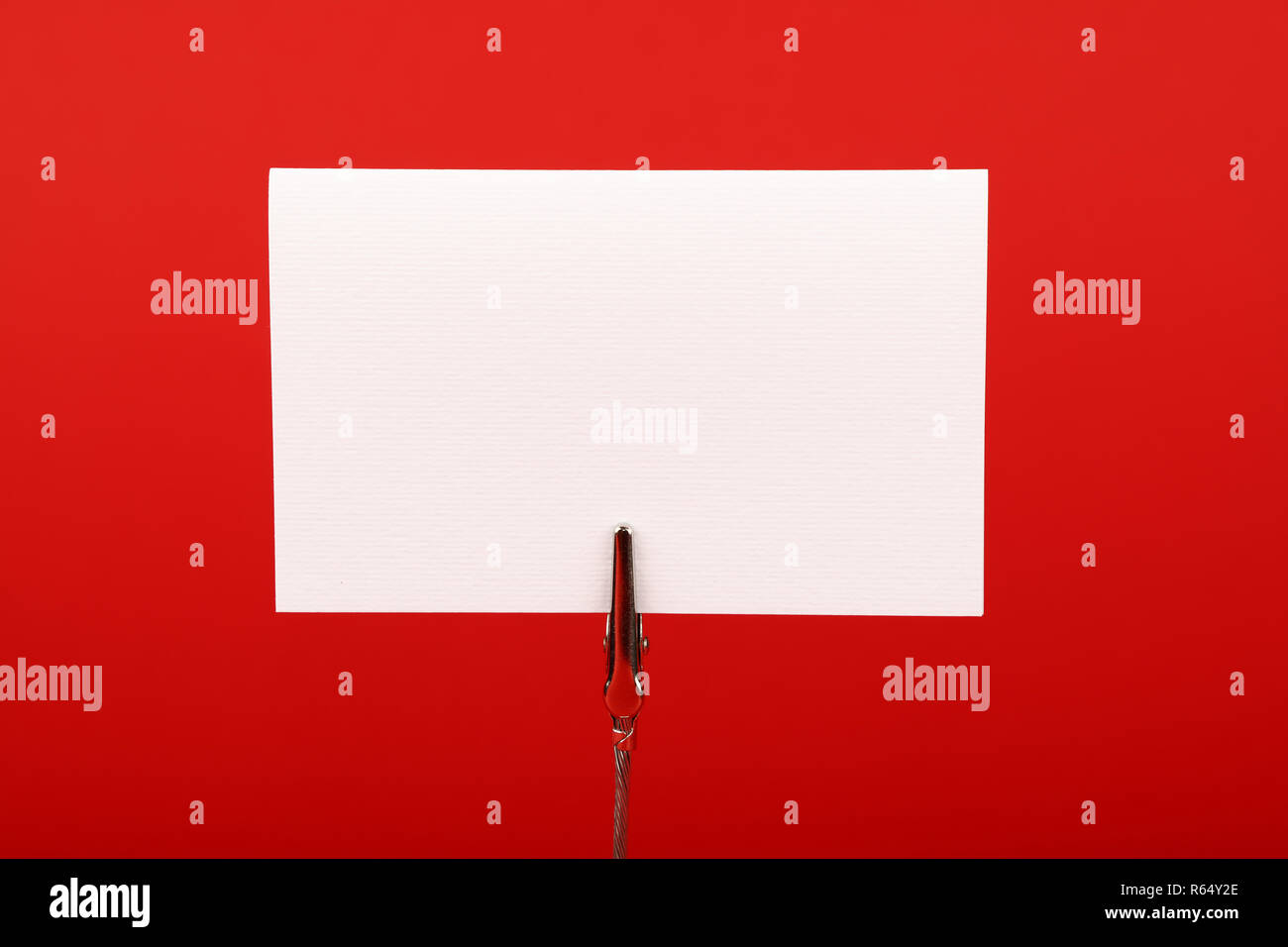 Blank white paper sign over red background Stock Photo - Alamy