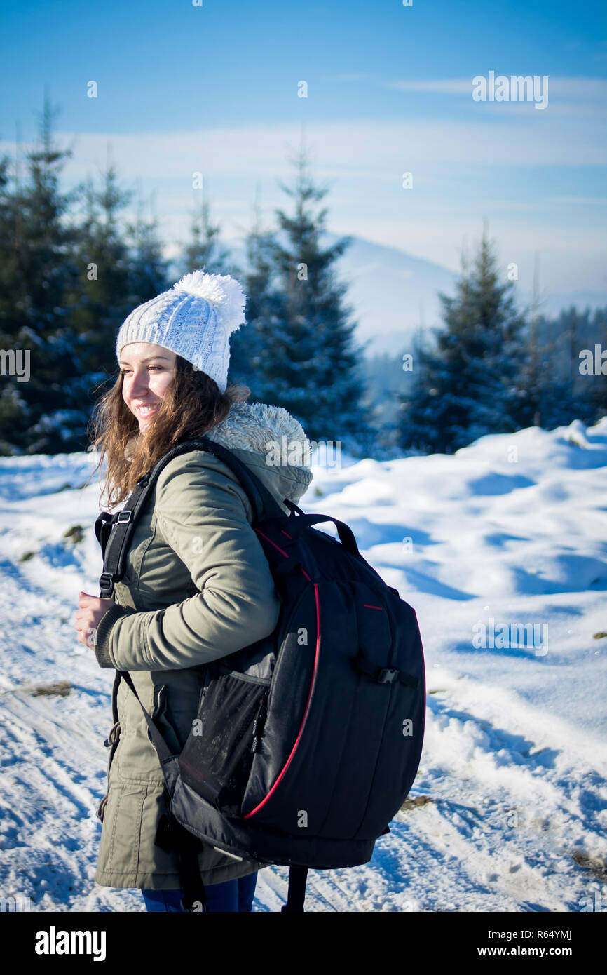 Girl backpacker walking in winter mountain forest in the Carpathians ...