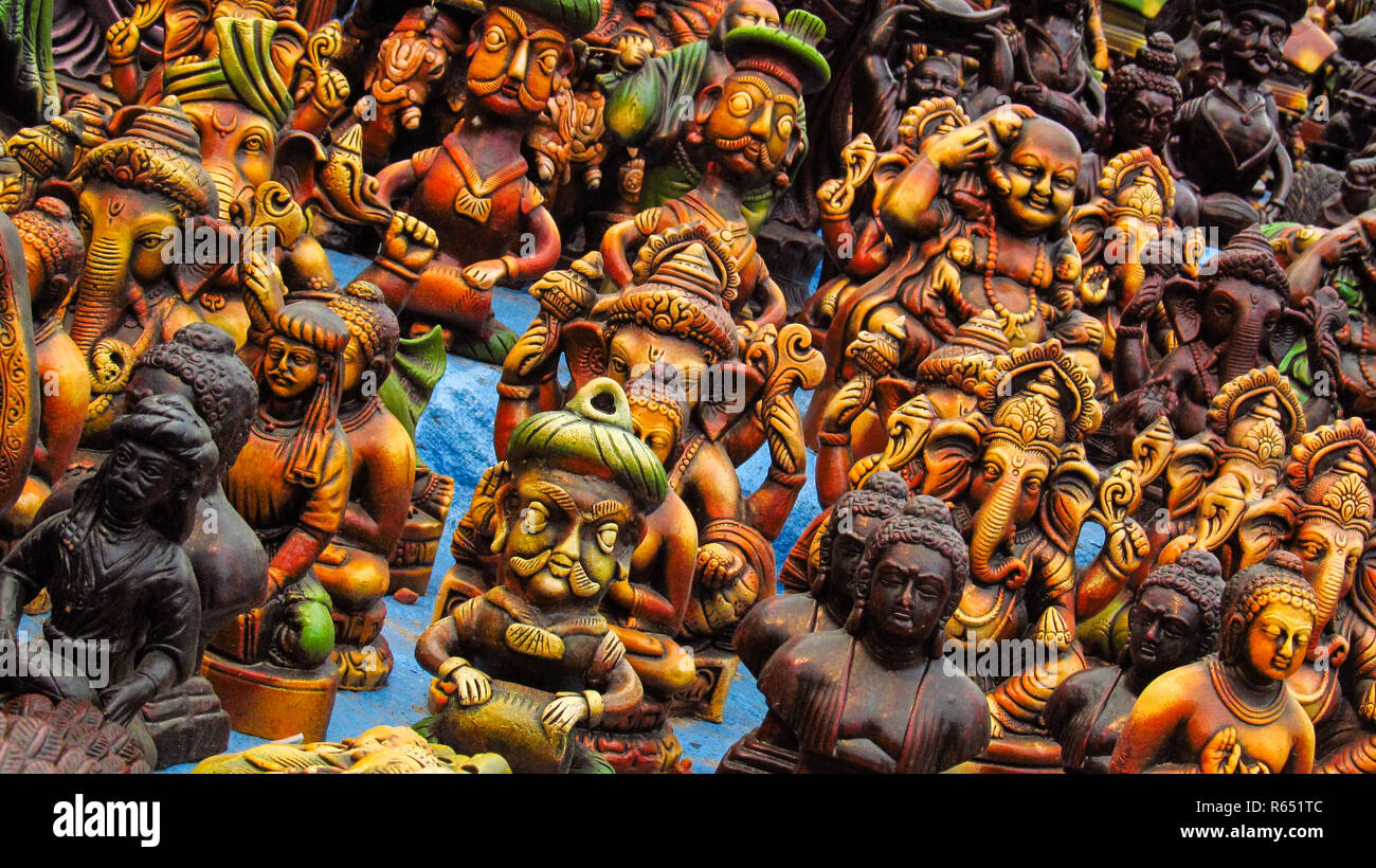 Miniature Hindu god statues (Ganesha, Shiva, Buddha) exhibited by a ...