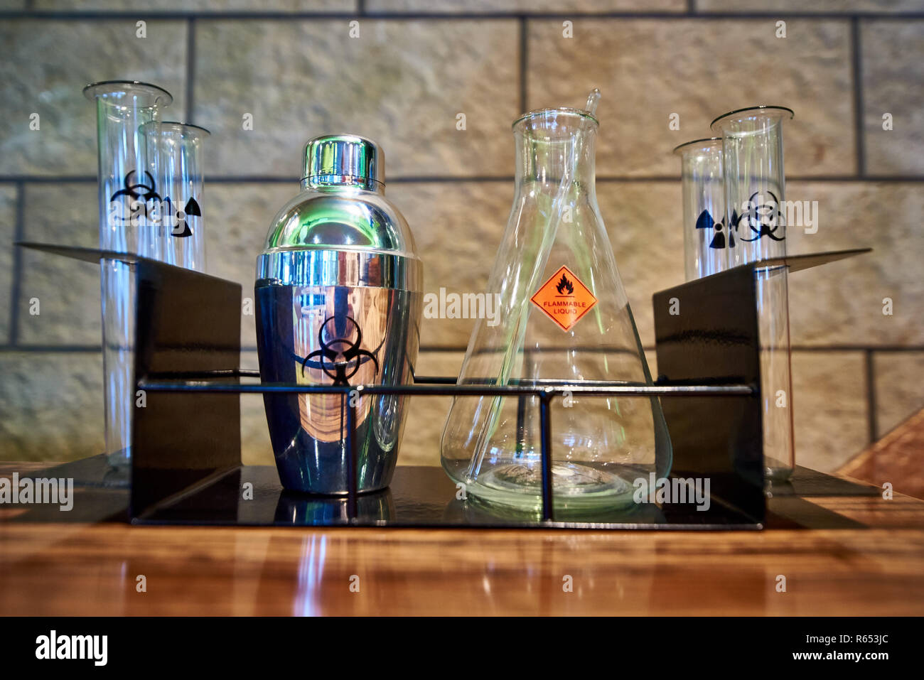 Shaker, flask and test tubes with the symbol of biological hazard ...