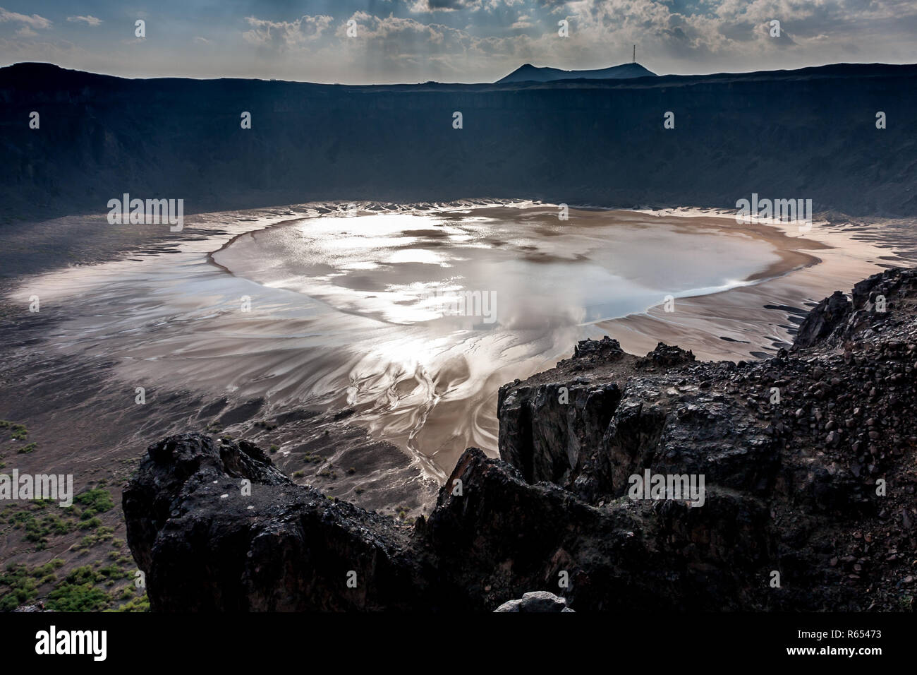 The sun reflects in water of the lake in the bottom of the Al Wahbah ...