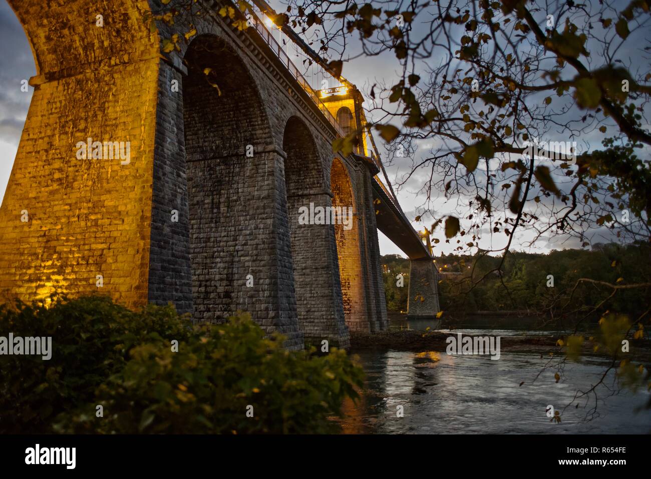 Limestone arches and columns of Menai Suspension Bridge at dawn, Menai ...