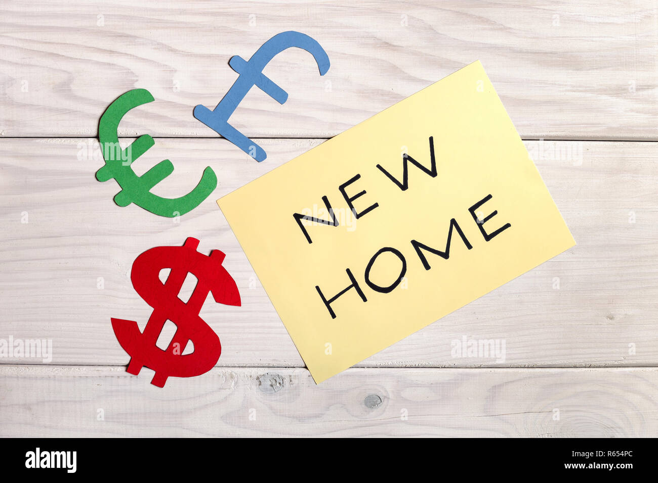 Photo of text new home with currency symbols wooden table Stock Photo ...