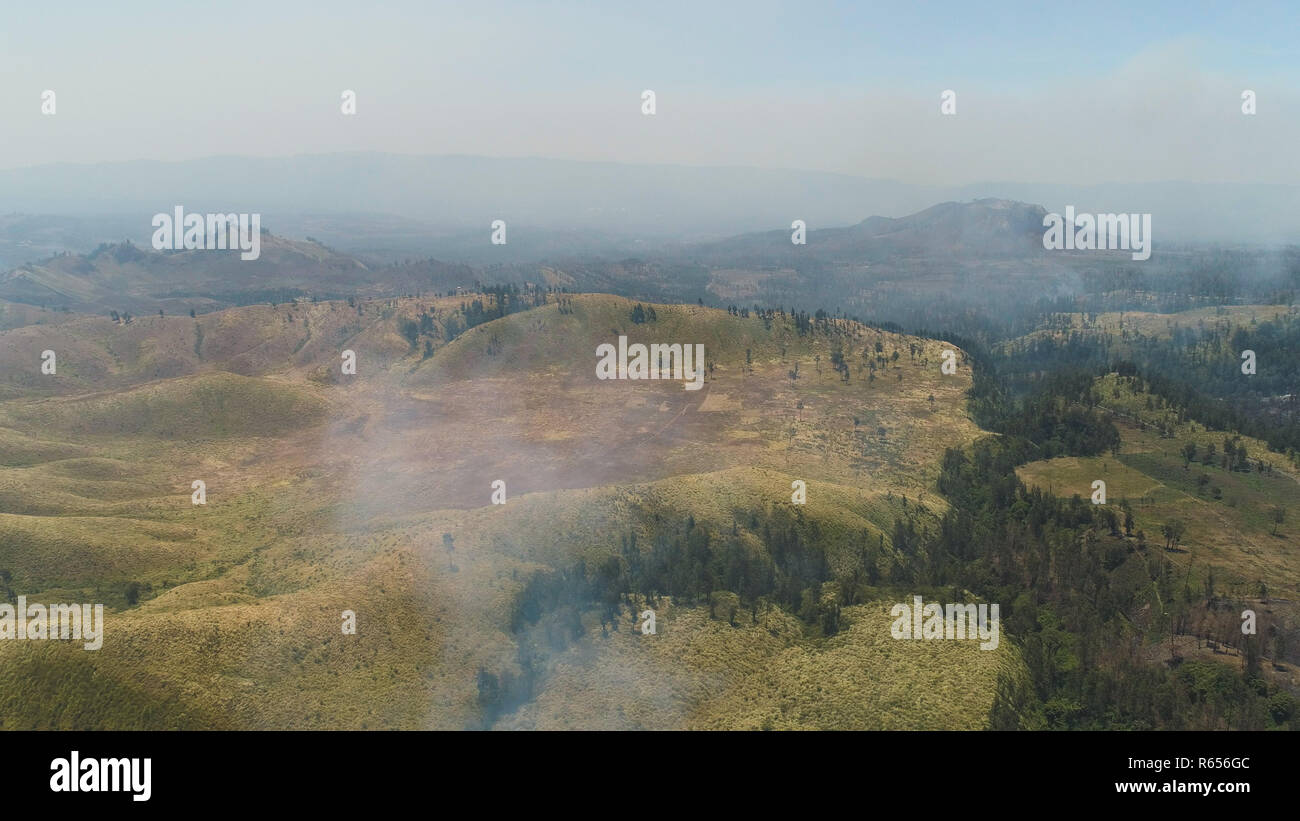 aerial view forest fire smoke on slopes hills. wild fire in tropical ...