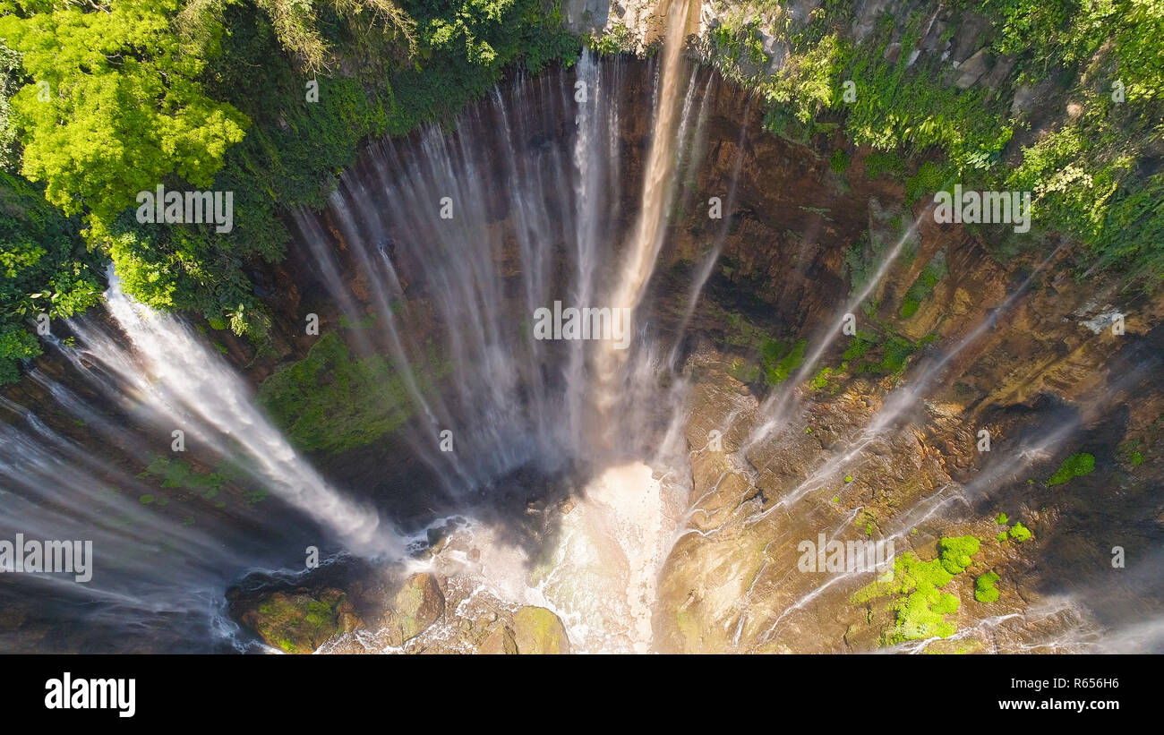 beautiful waterfall Coban Sewu in tropical forest, Java Indonesia ...