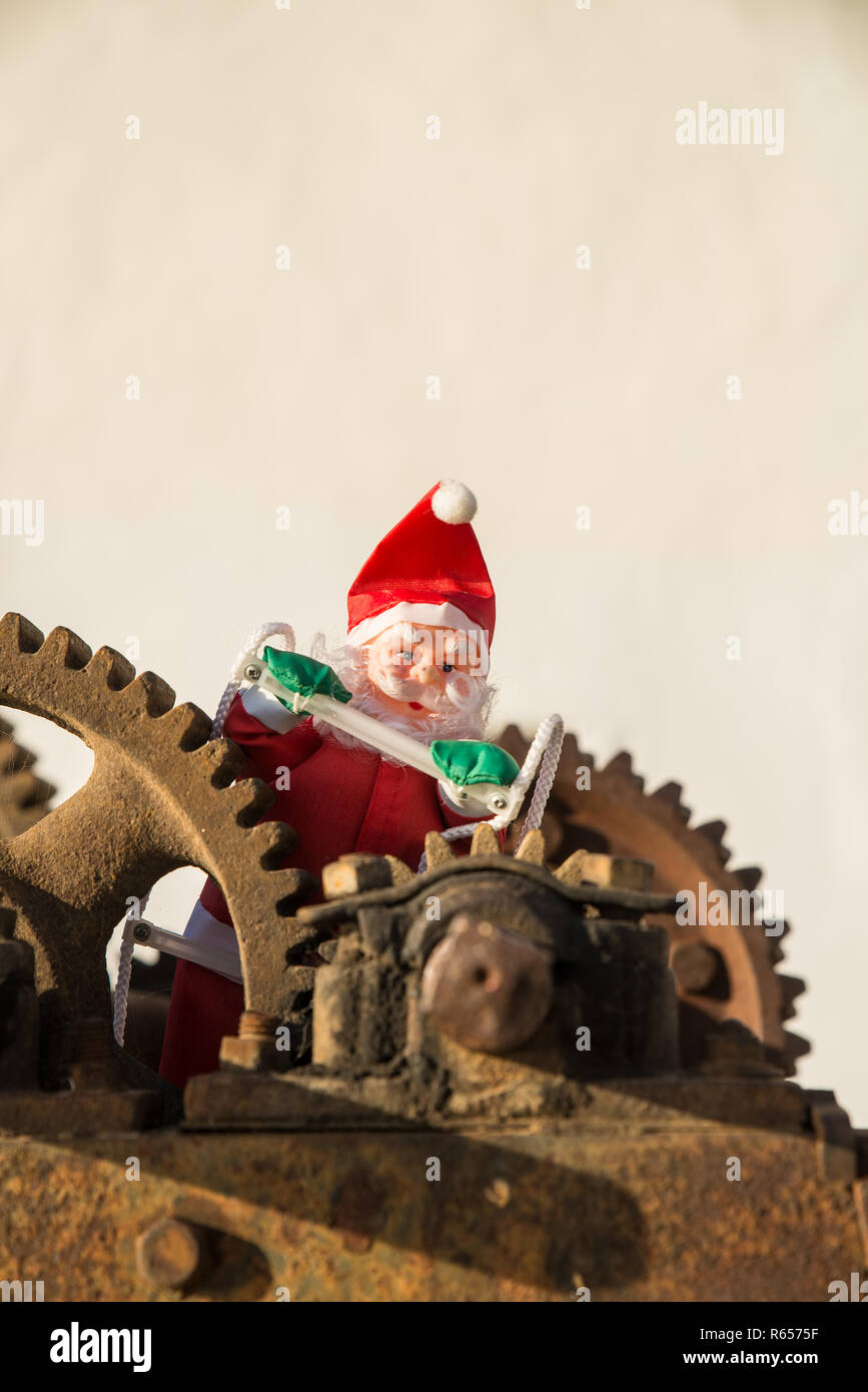 Santa in the cogwheels of consumerism, a concept Stock Photo - Alamy