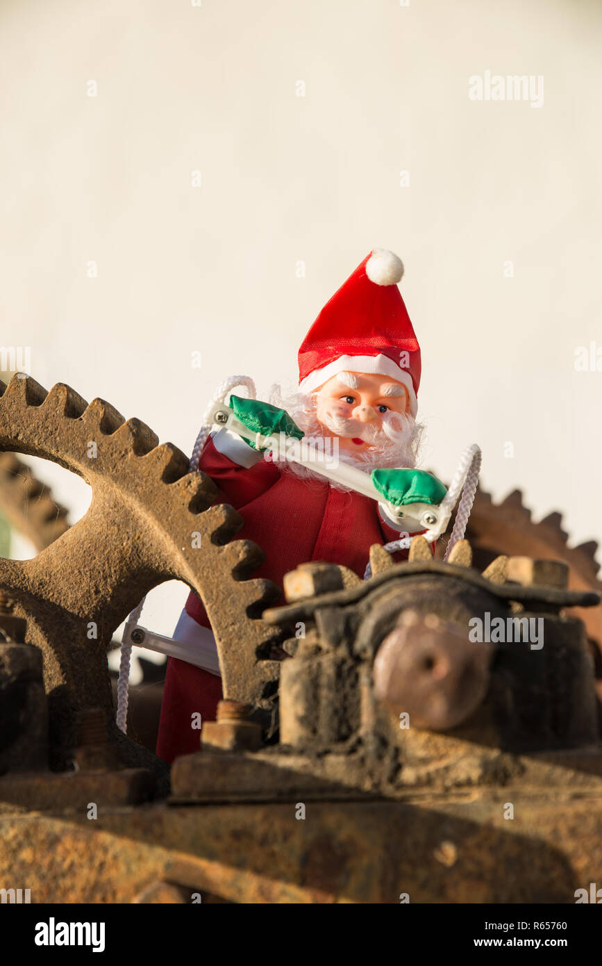 Santa in the cogwheels of consumerism, a concept Stock Photo - Alamy