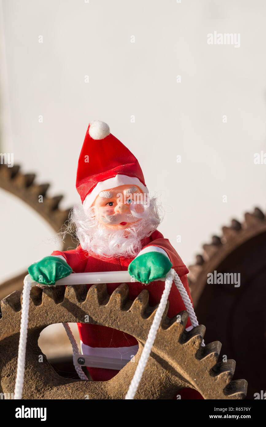 Santa in the cogwheels of consumerism, a concept Stock Photo - Alamy