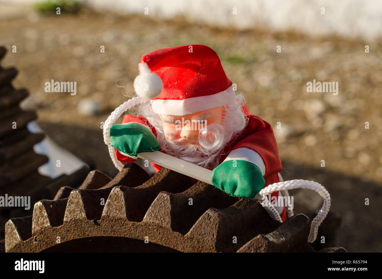 Santa in the cogwheels of consumerism, a concept Stock Photo - Alamy