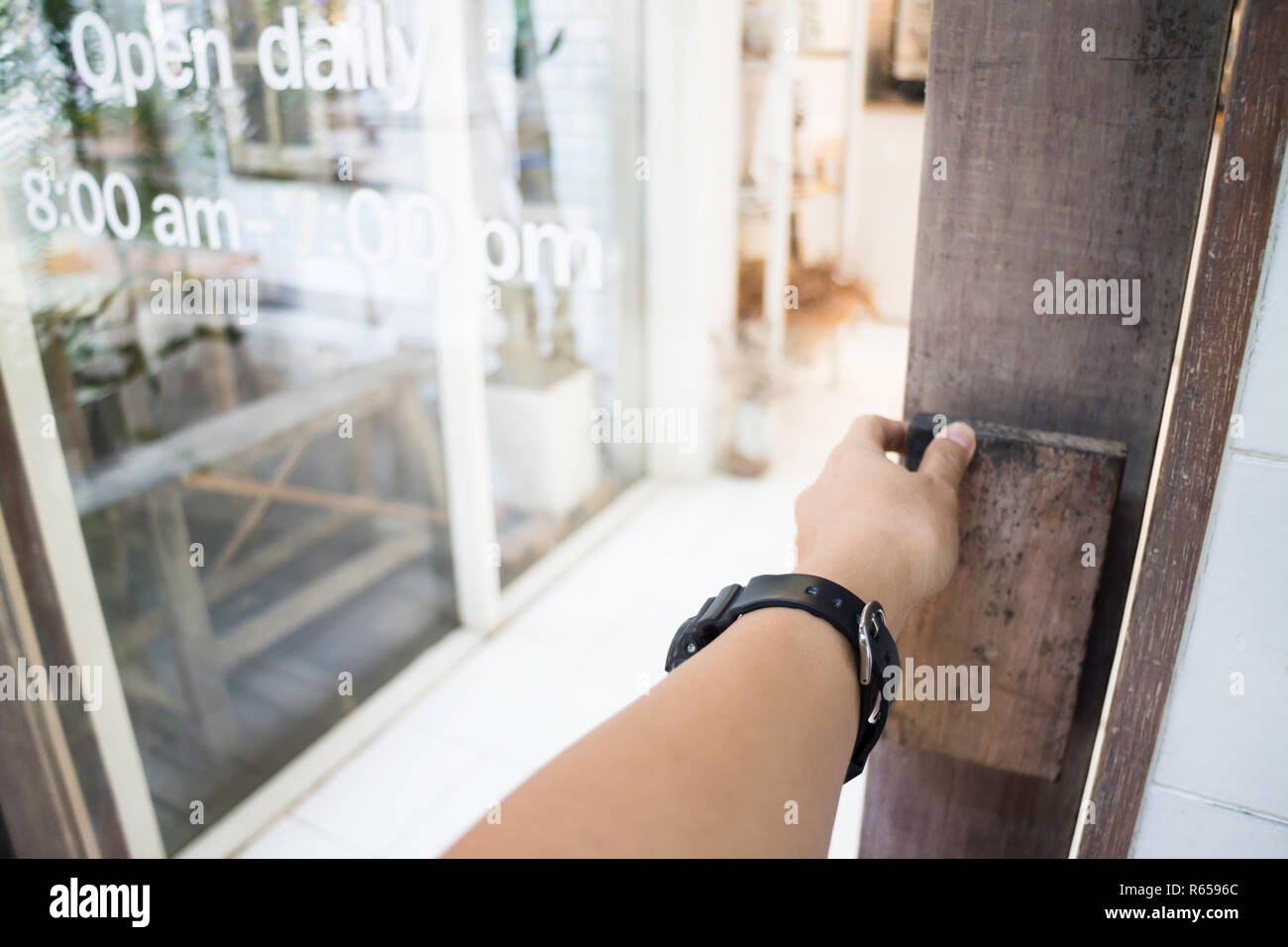 Woman hand opening shop door Stock Photo - Alamy