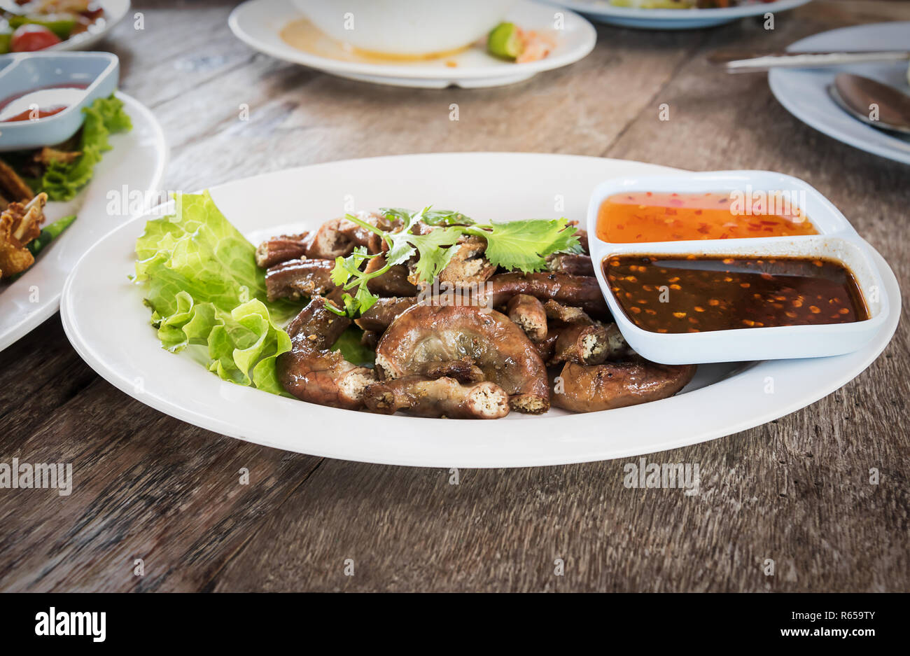 Pig's intestines grilled thai style food Stock Photo - Alamy