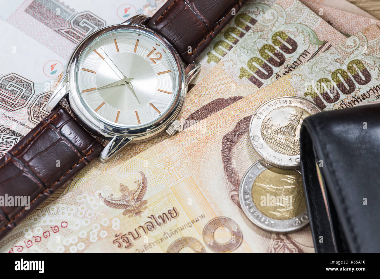 Watch and wallet on banknote Stock Photo - Alamy