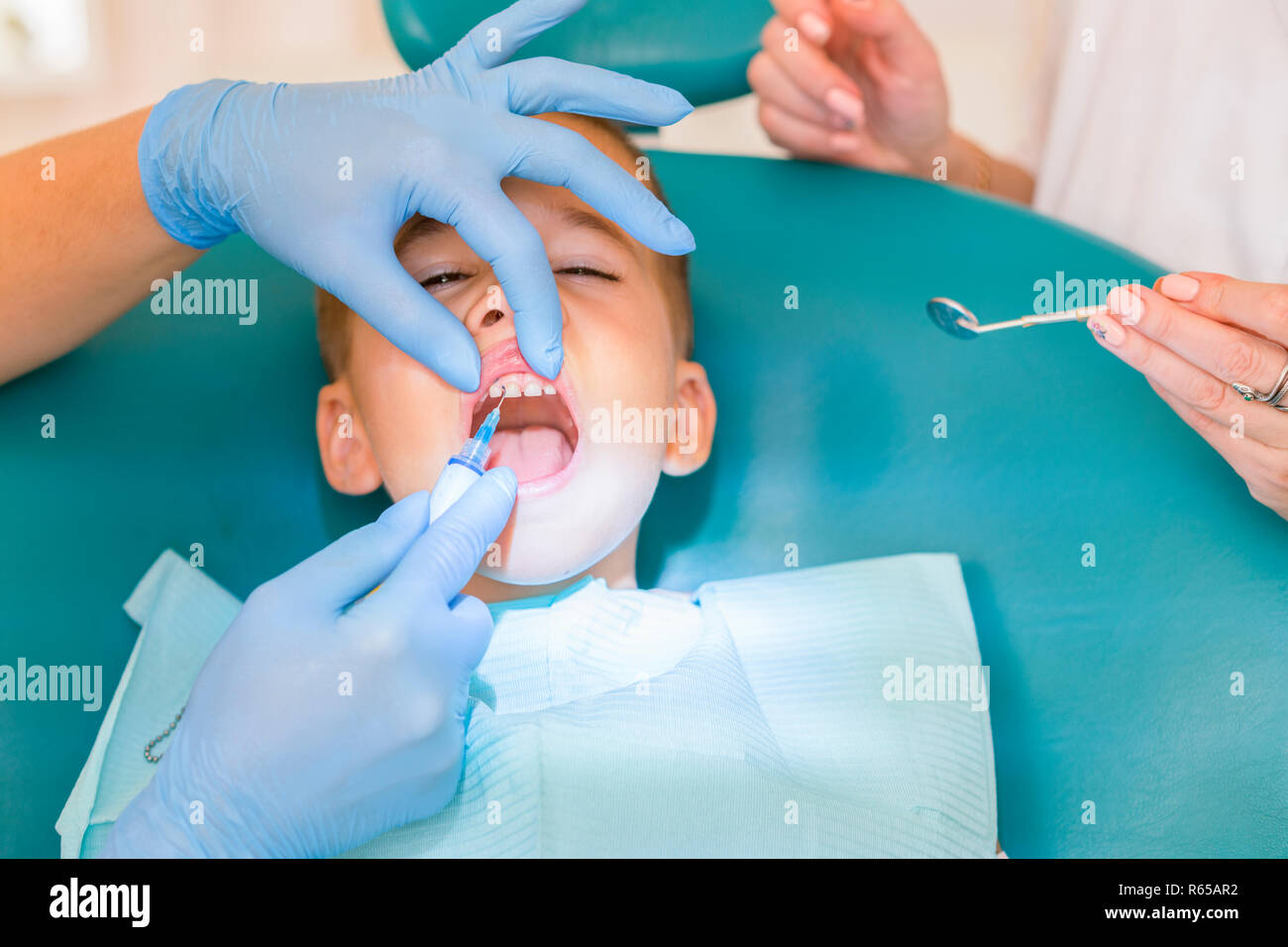 Dentist is treating a boy's teeth.Children's dentistry, Pediatric ...