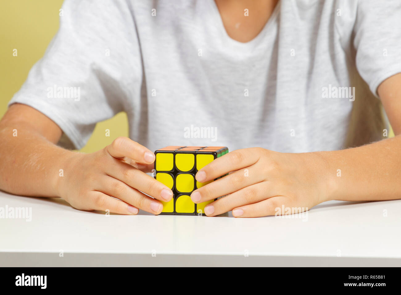 Kid playing with Rubik cube Stock Photo - Alamy