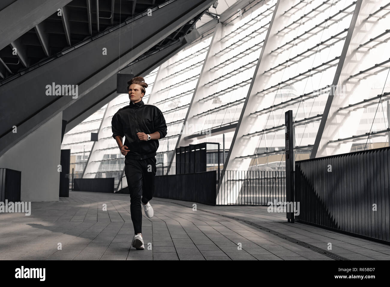 Young athlete is running near the stadium Stock Photo - Alamy