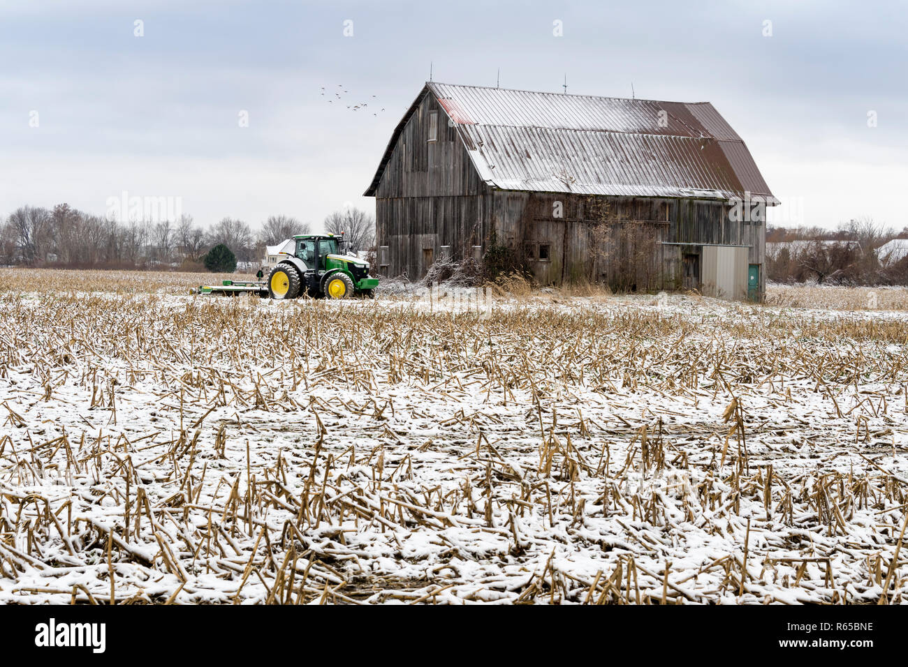 Winter barn witgh tractor on overcast day Stock Photo - Alamy