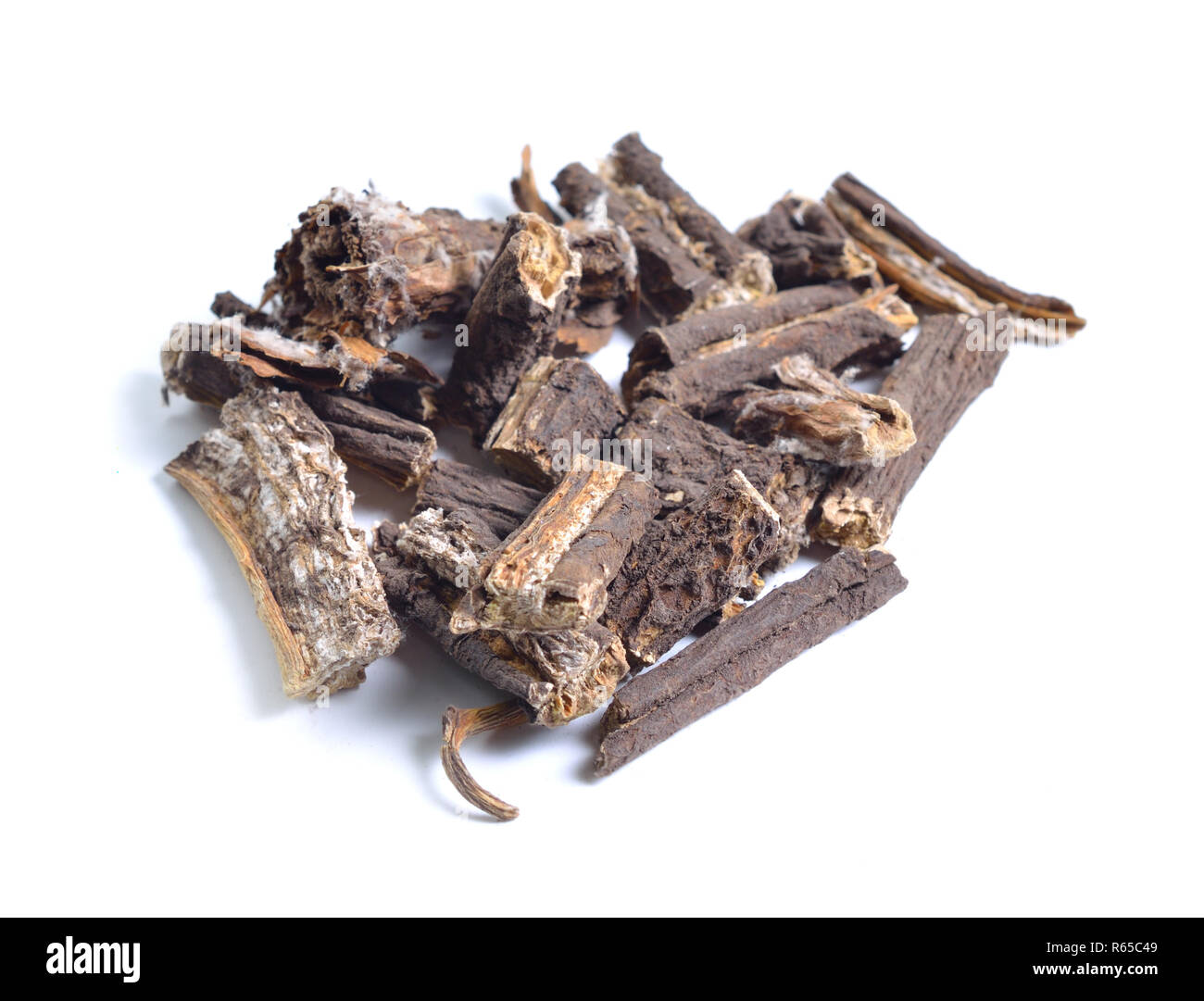 Dried medicinal herbs raw materials isolated on white. Root of Arctium ...
