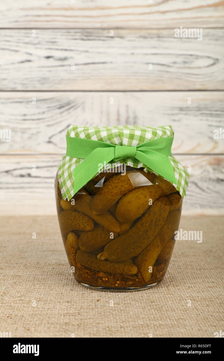 Jar of pickled small gherkin cucumbers on table Stock Photo - Alamy