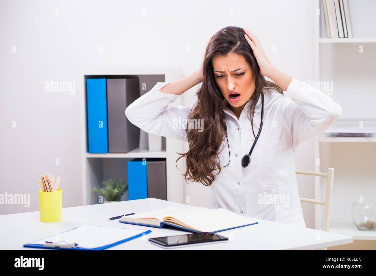 Female doctor is in panic because of something while she is working at ...