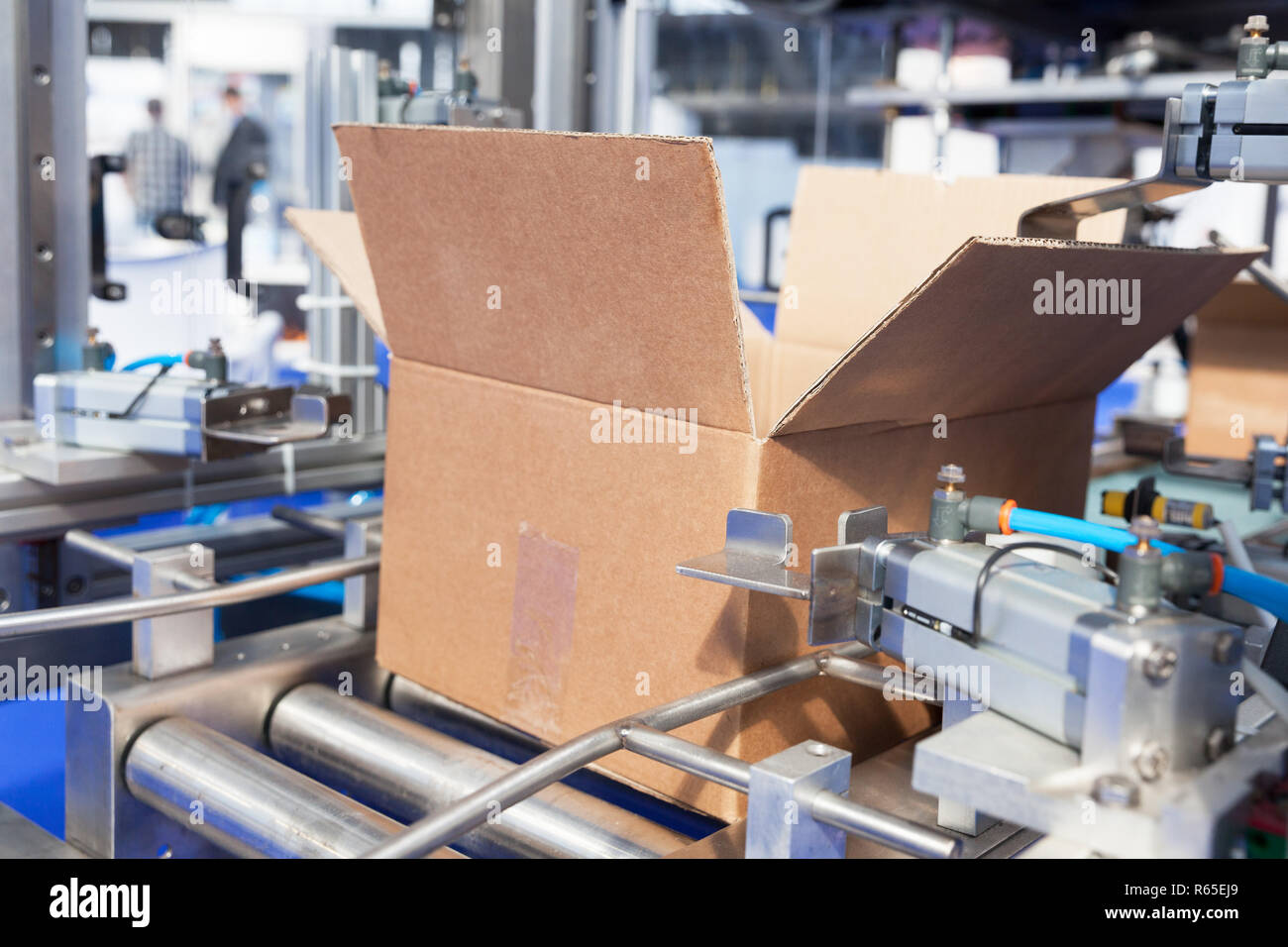 Cardboard package box packing machine Stock Photo - Alamy