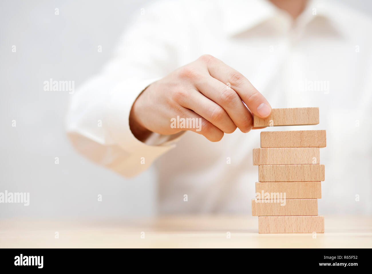 Man's hand stacking wooden blocks. Business development concept Stock ...