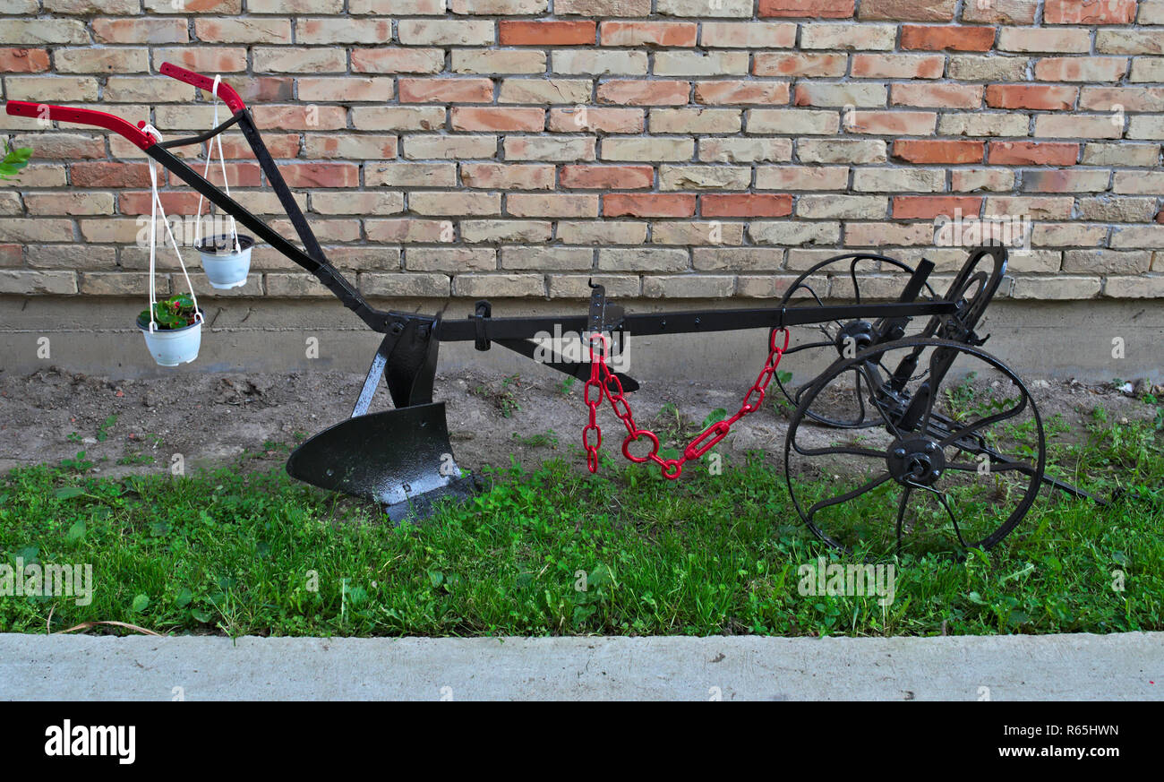 Old restored plow, for farming Stock Photo - Alamy