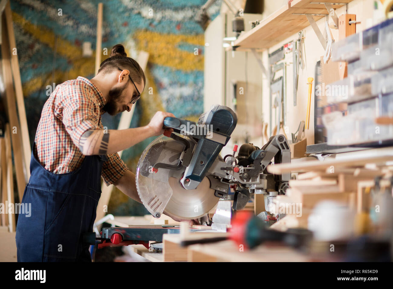 Contemporary Worker Cutting Wood Stock Photo - Alamy