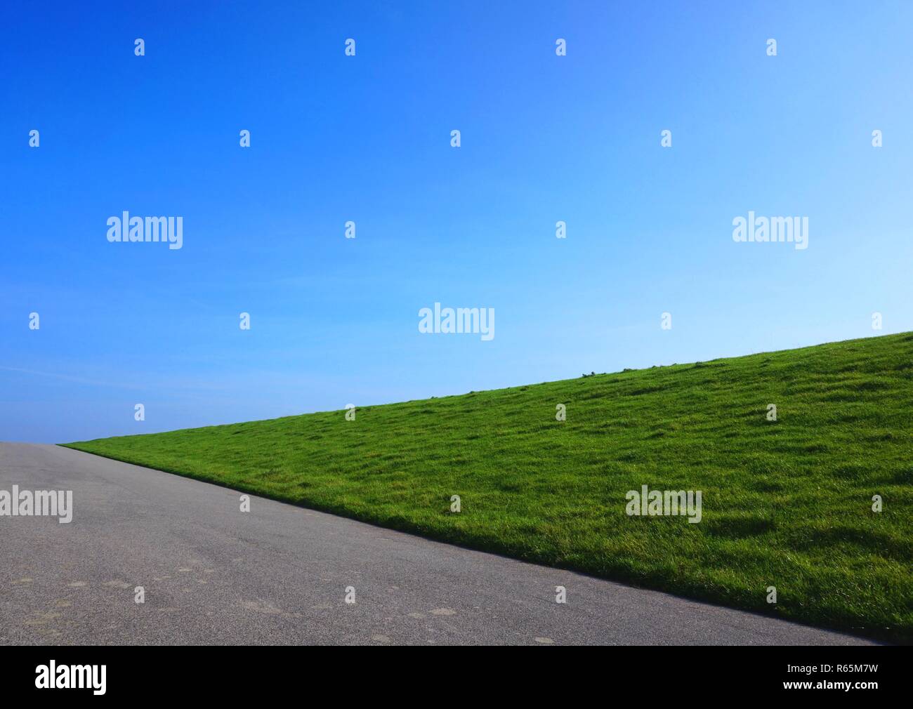 empty road with grass field and blue sky Stock Photo - Alamy