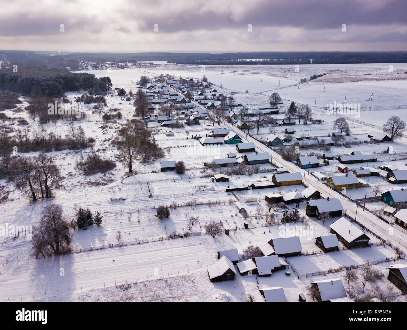 Winter rural landscape. Aerial view of village, houses, meadow and ...