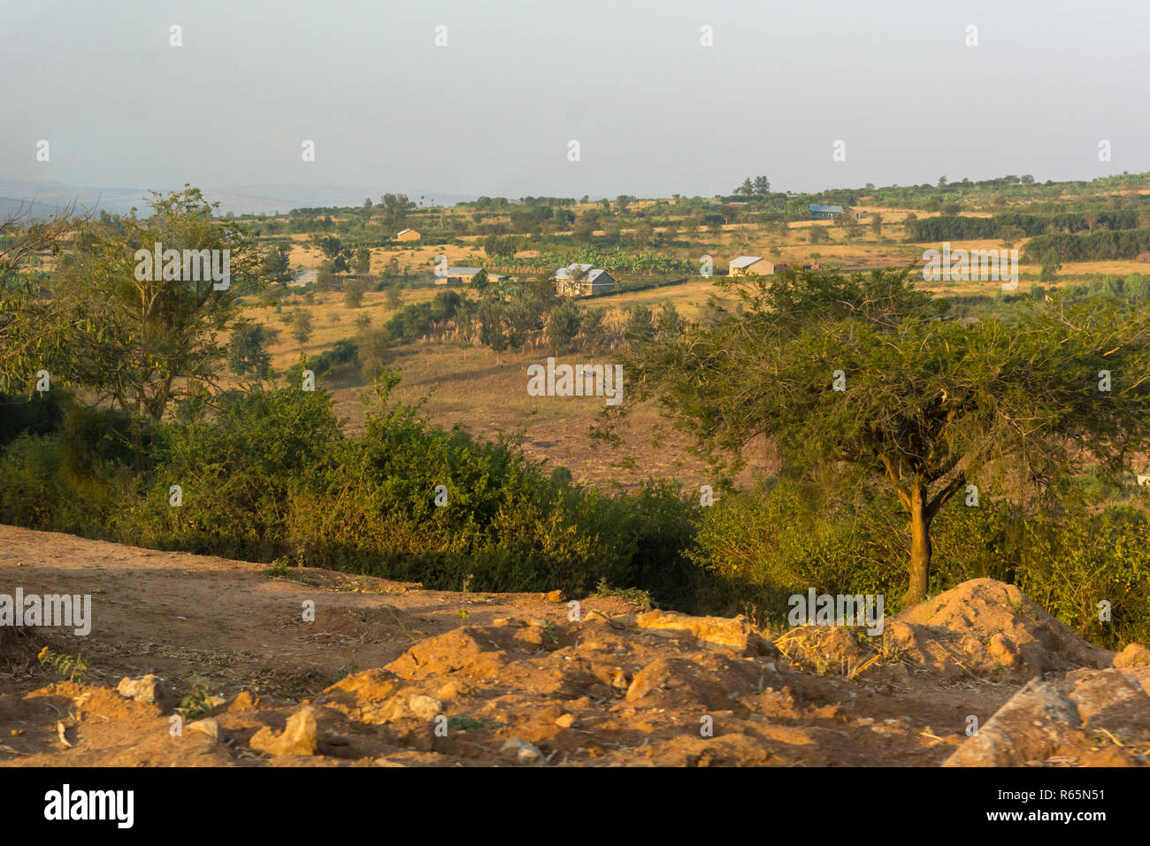 Traditional houses surrounded by savannah countryside in Rwanda Stock ...