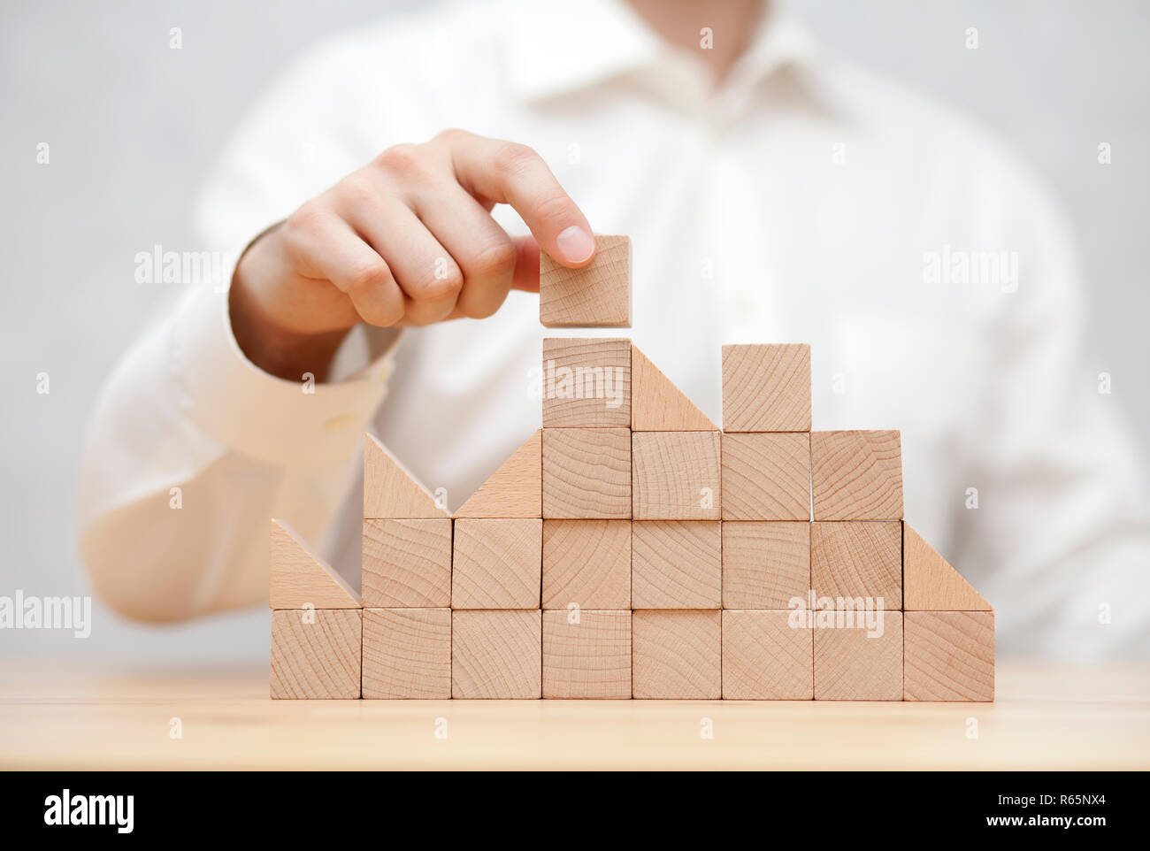 Man's hand stacking wooden blocks. Business development concept Stock ...