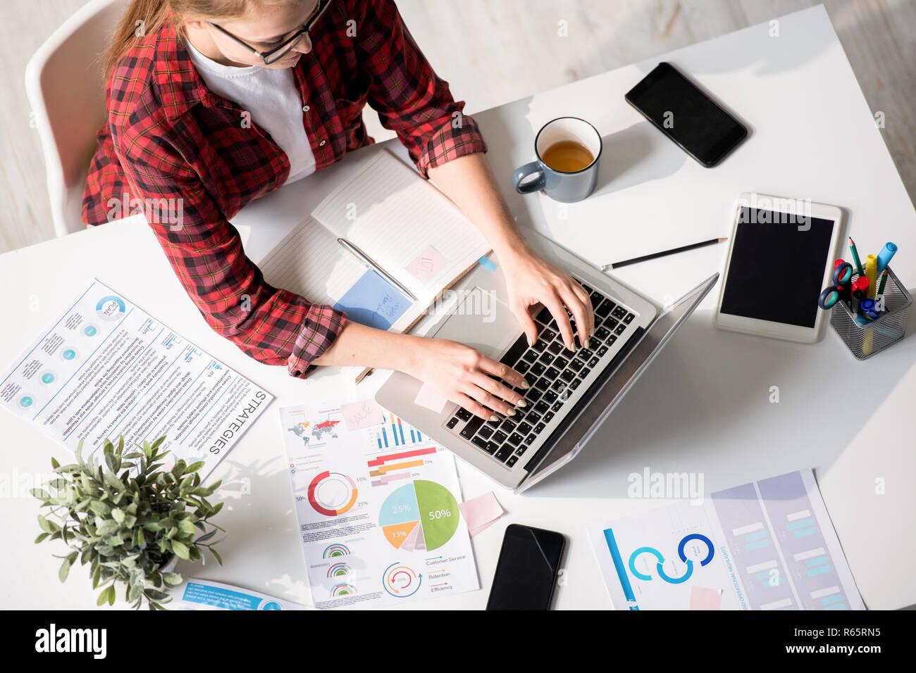 Busy programmer typing on laptop in office Stock Photo - Alamy