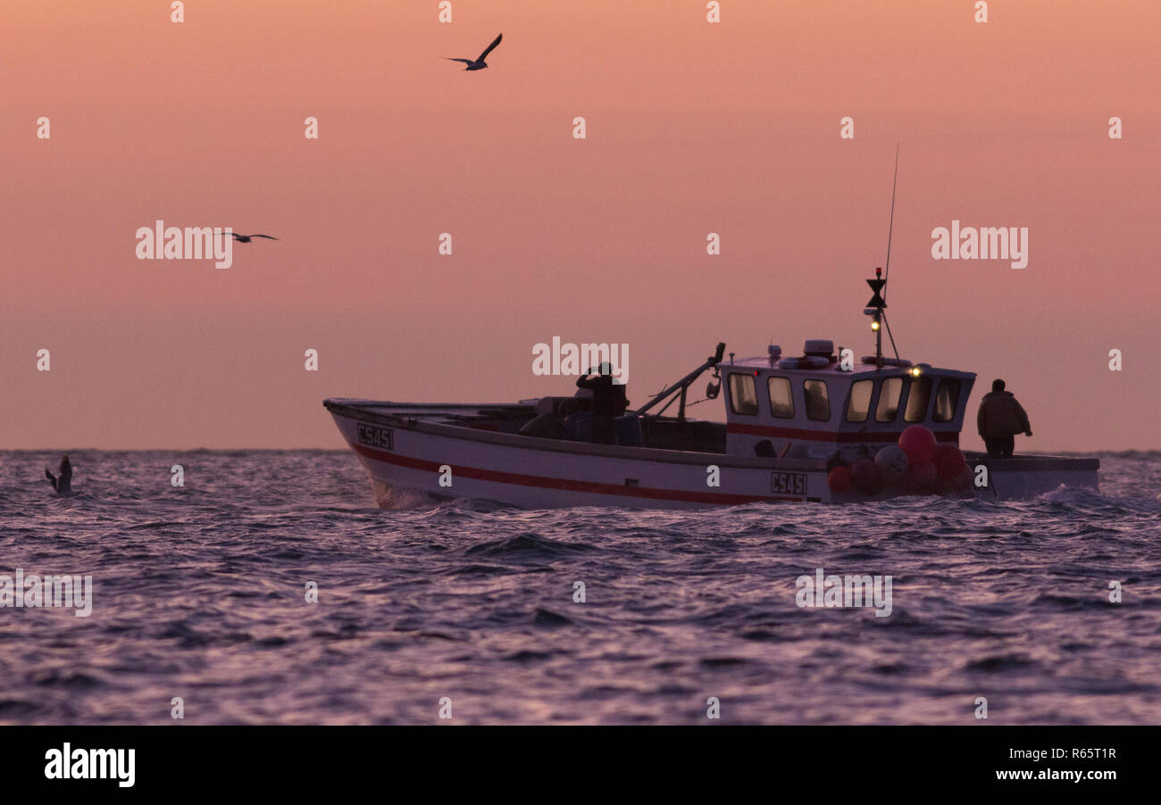 A fishing boat leaving Bembridge Harbour at Sunrise near St, Helen's ...