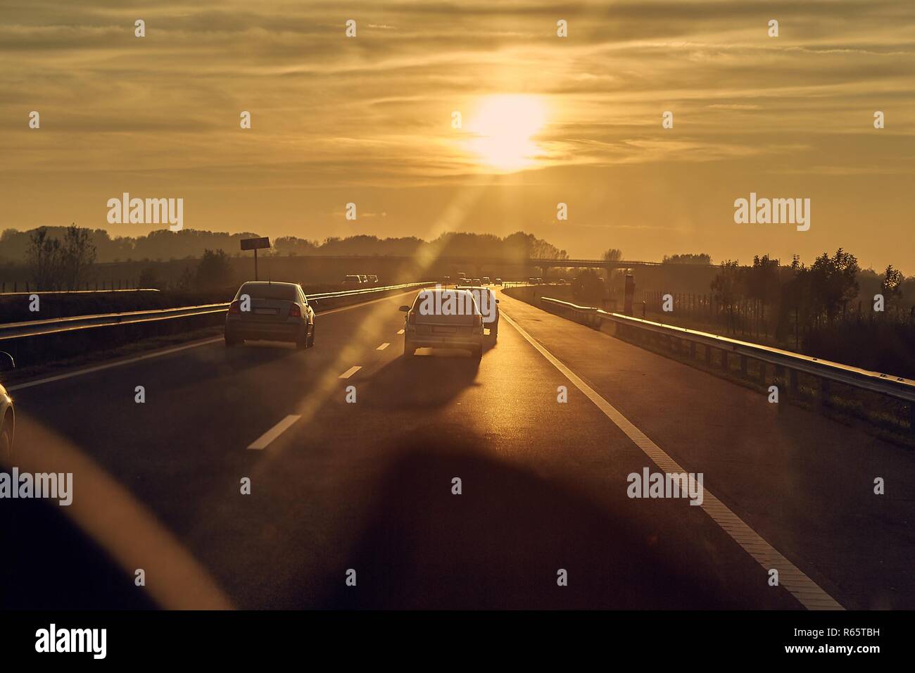 Driving in sunset Stock Photo - Alamy