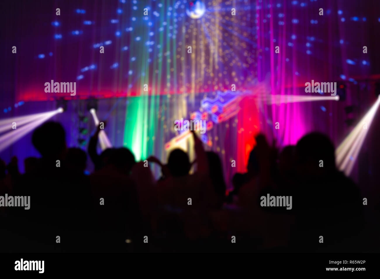 Blurred concept at concert party with audience and colourful led ...
