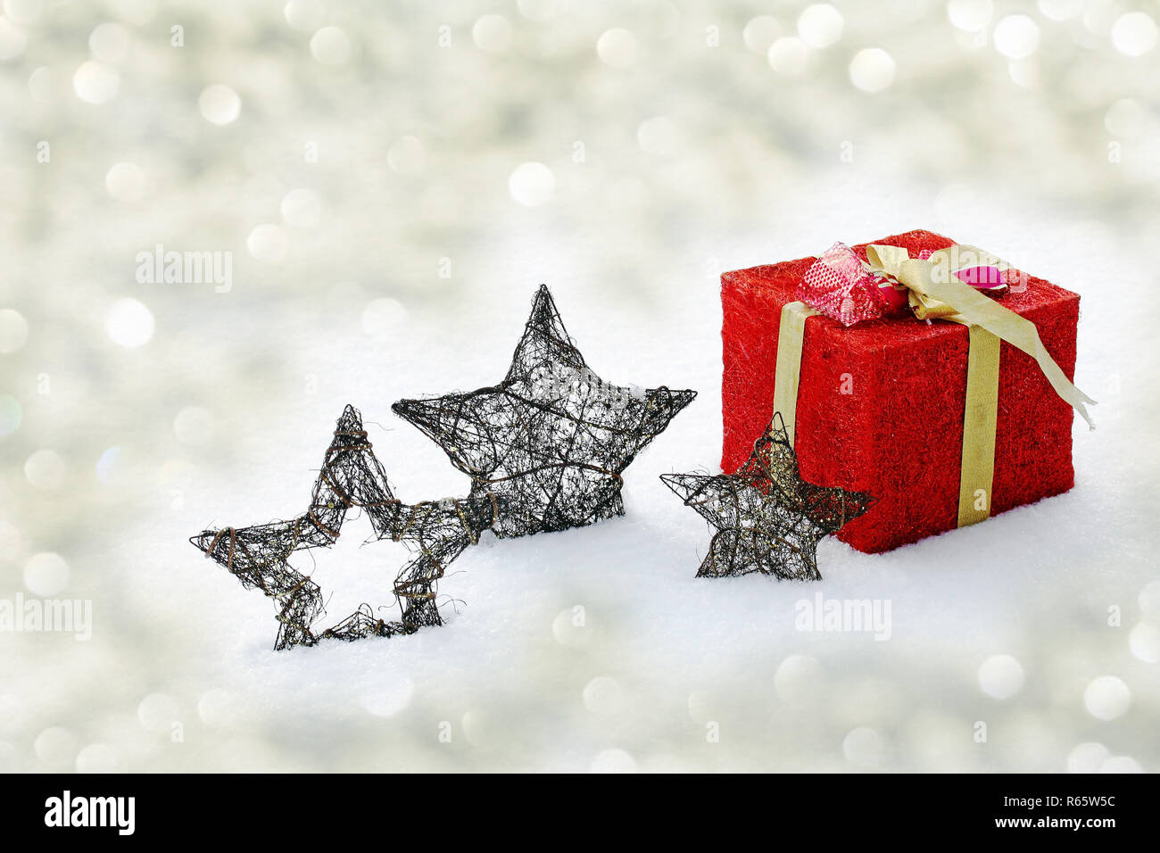 big red christmas gift and christmas stars in the glistening snow Stock ...