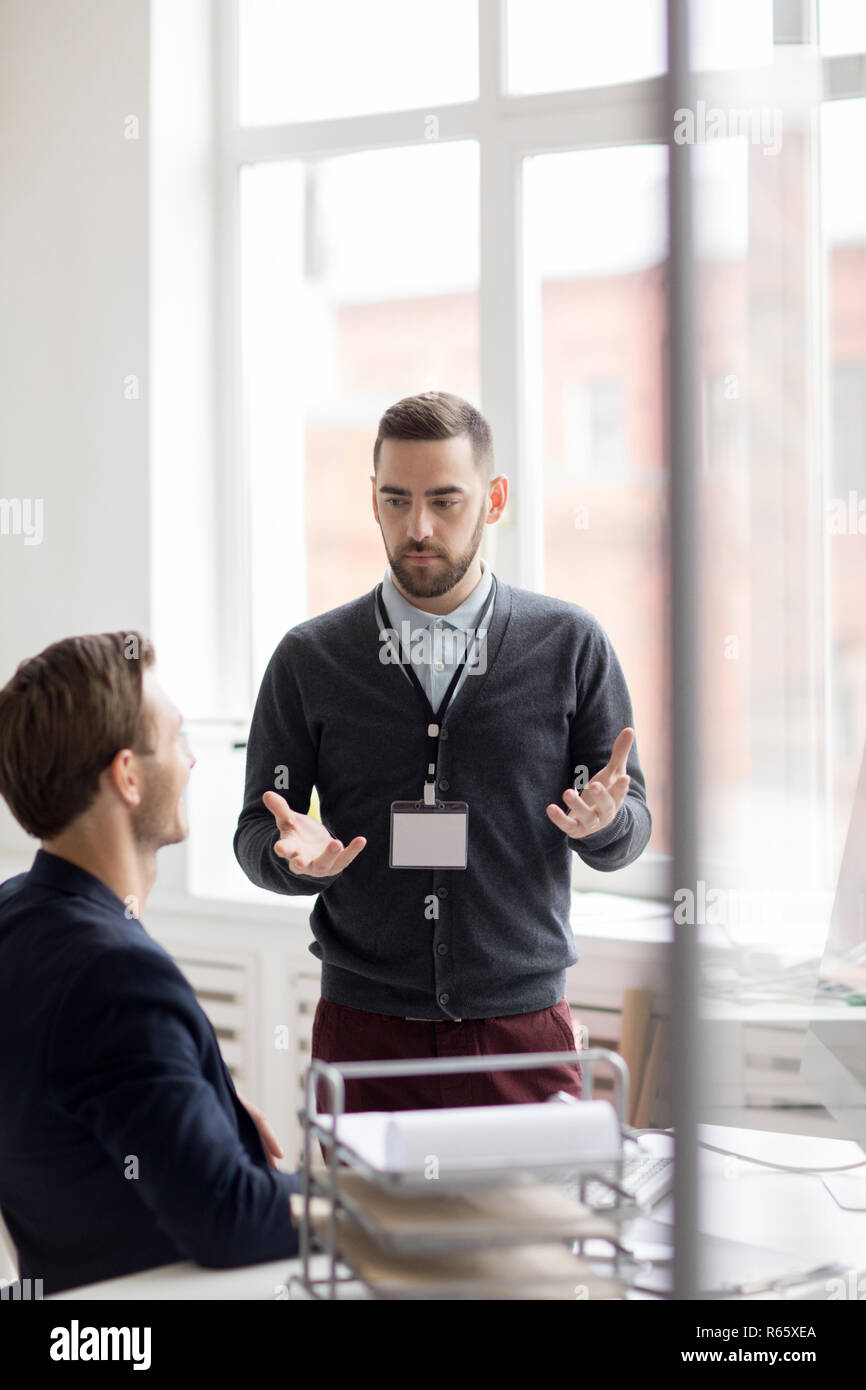 Office Worker Talking to Colleague Stock Photo - Alamy