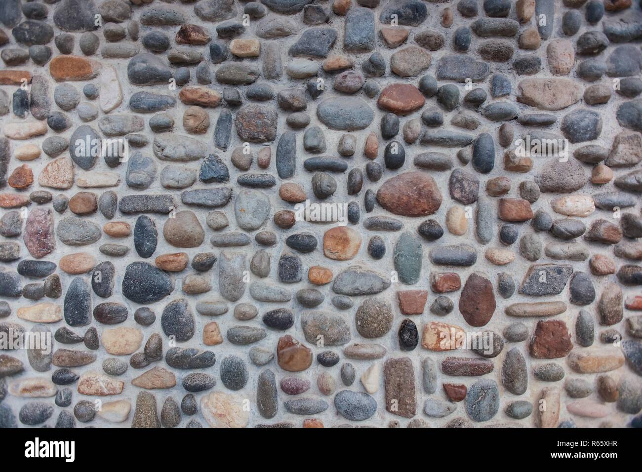 A picturesque handmade pebble stone wall mosaic Stock Photo - Alamy