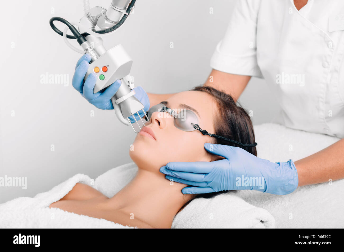 woman getting laser facial treatment, aesthetic surgery Stock Photo - Alamy