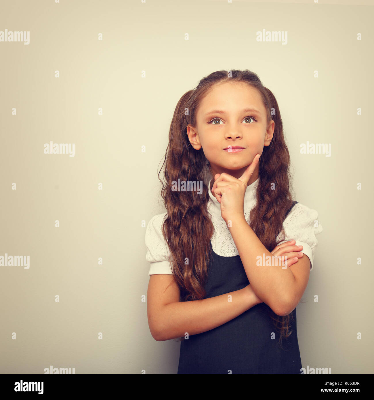 Fun pupil girl school uniform thinking and looking up on empty copy ...