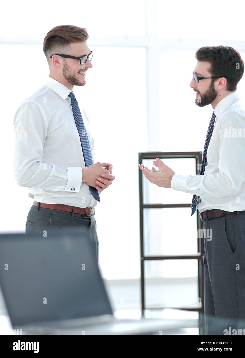 two businessmen talking standing in the office Stock Photo - Alamy