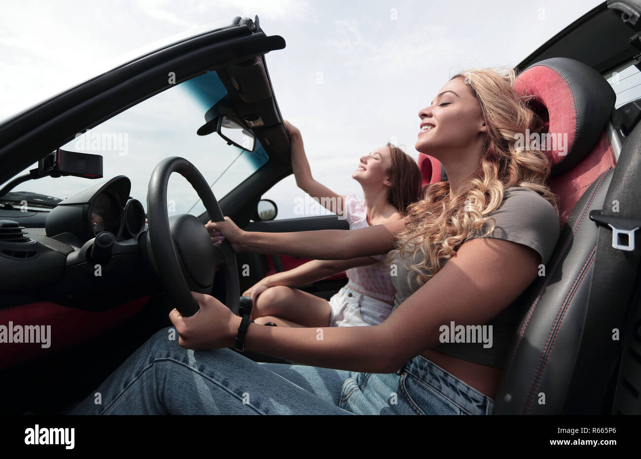 side view.two happy girls riding in the car Stock Photo - Alamy