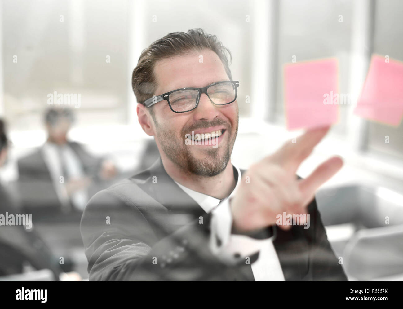 close up.a successful employee of a sticky note on glass Stock Photo ...