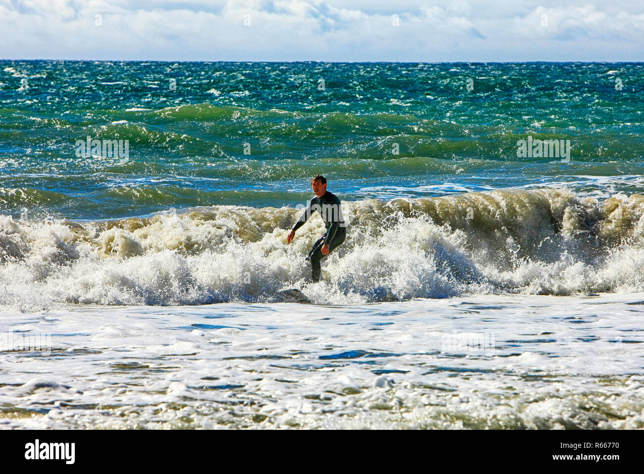 Man surfboarding in the Pacific Ocean at Hendry's Beach nr Santa ...