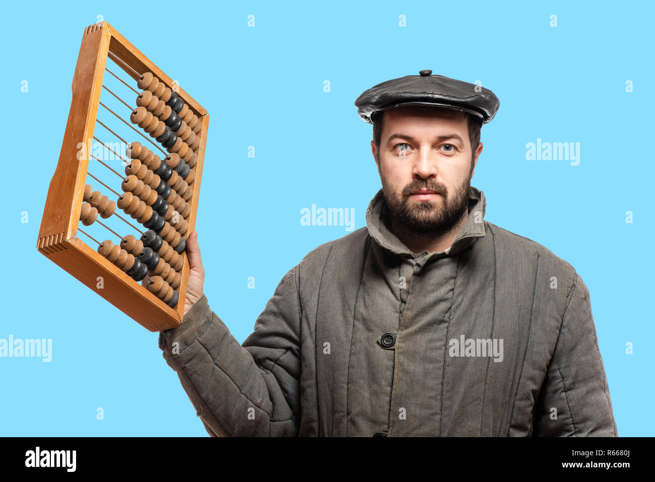 Old fashioned bearded man with retro wooden abacus, studio shot ...