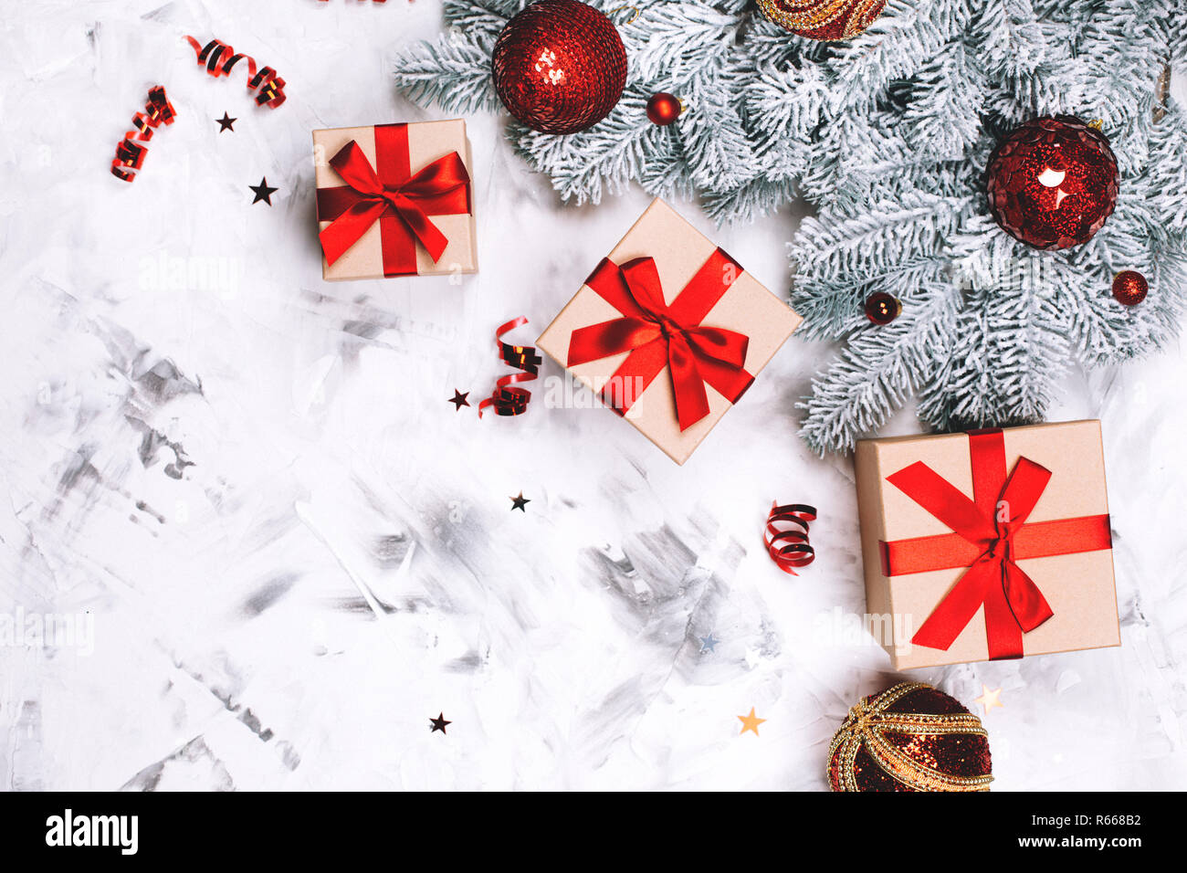 Three present boxes with red bow, christmas balls and snow fir-tree on ...